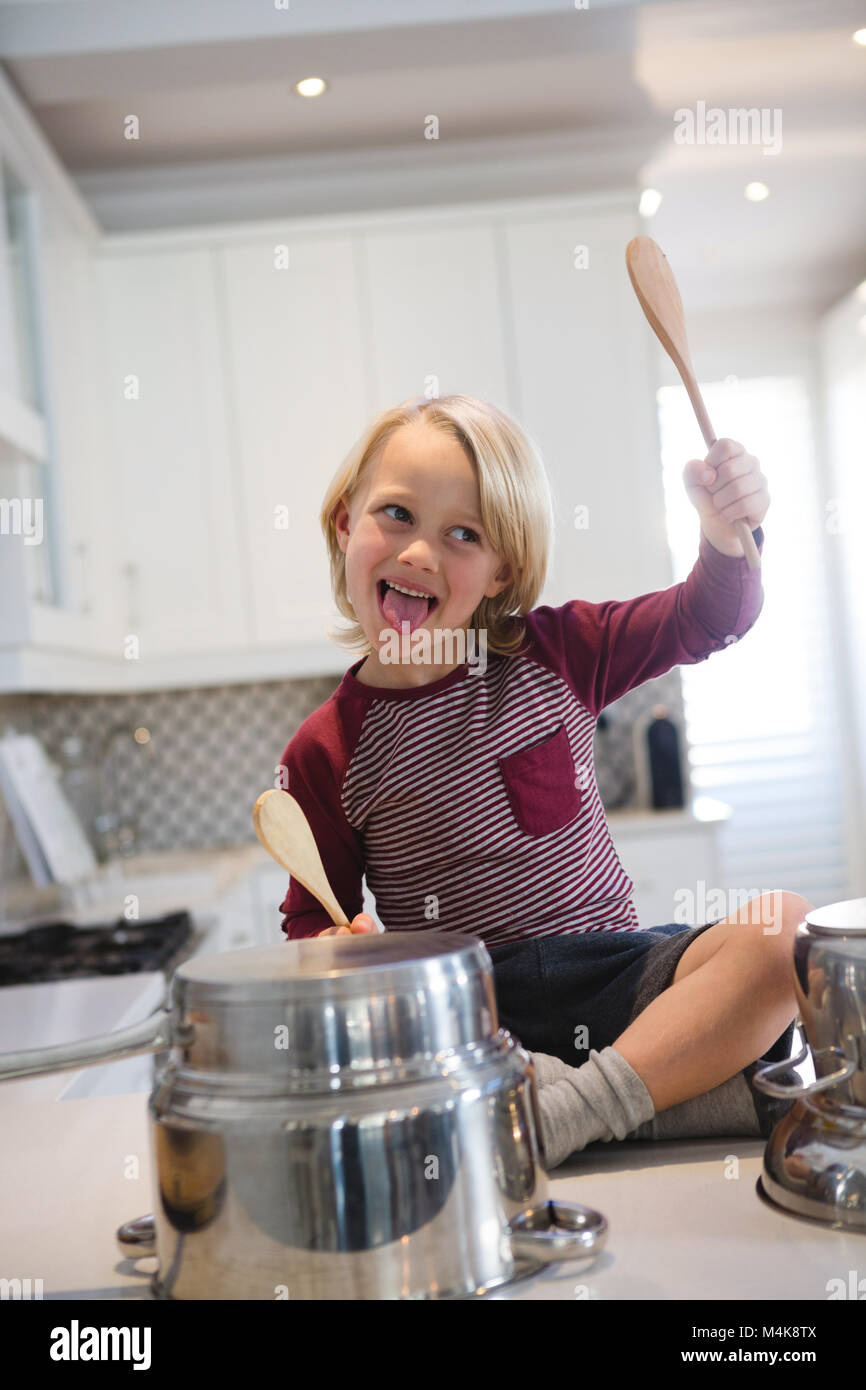 Boy playing with utensils in kitchen Stock Photo - Alamy