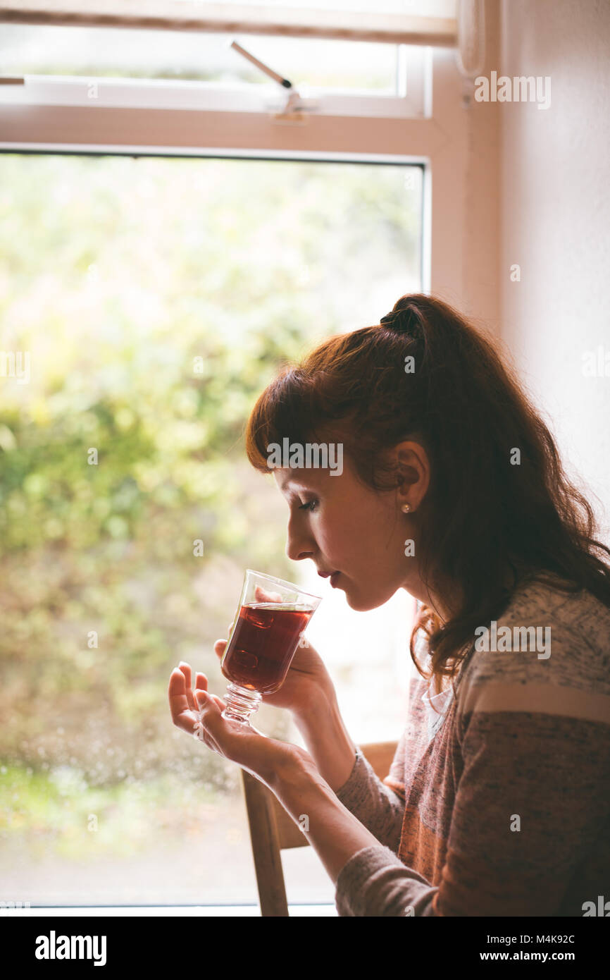 Woman having a tea at home Stock Photo - Alamy