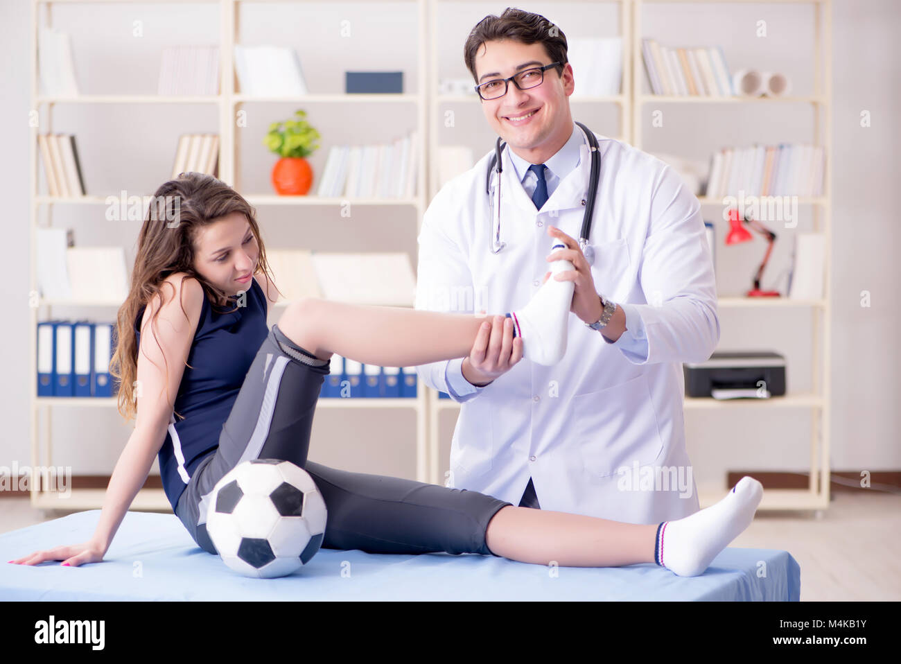 Man doctor taking care of sports injury Stock Photo - Alamy