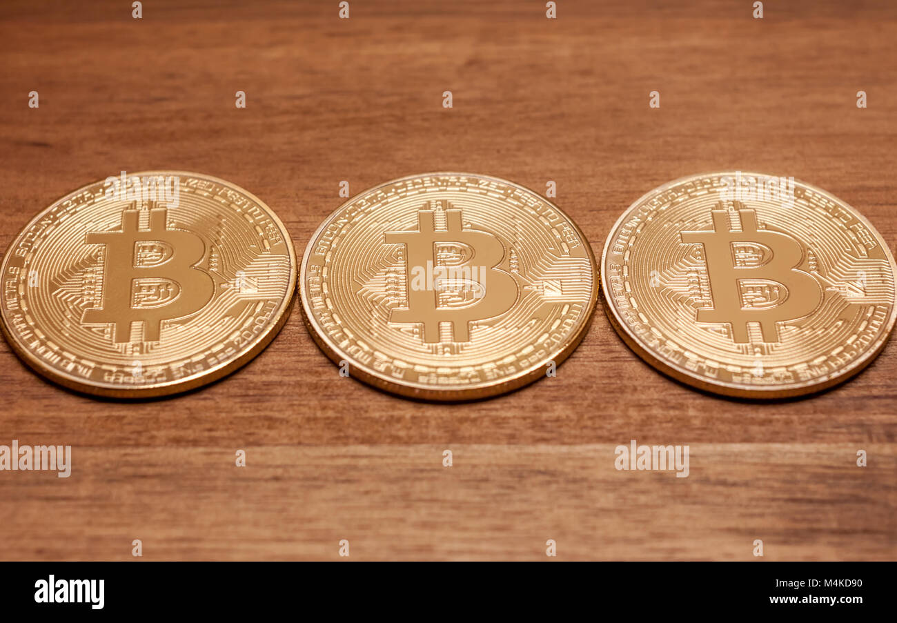 three golden bitcoin coins Stock Photo - Alamy