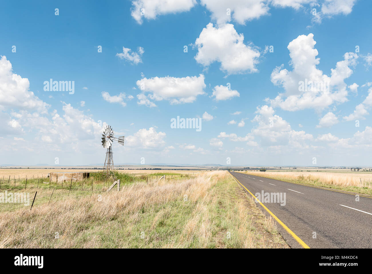 A farm scene with water-pumping windmill and dam next to the R703-road ...