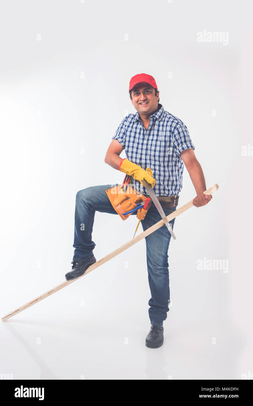 Handsome Indian Carpenter or wood worker in action, isolated over white ...