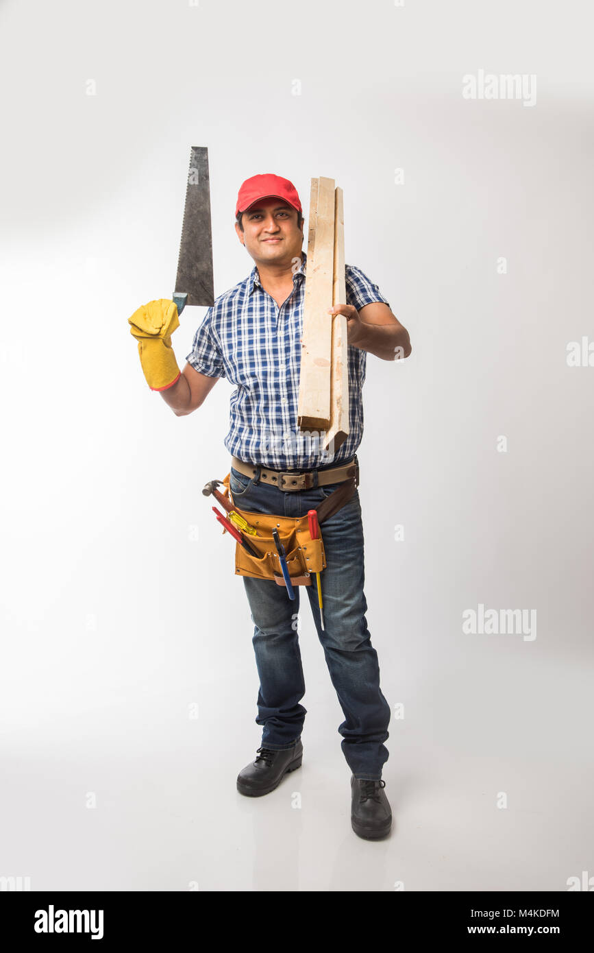 Handsome Indian Carpenter or wood worker in action, isolated over white ...