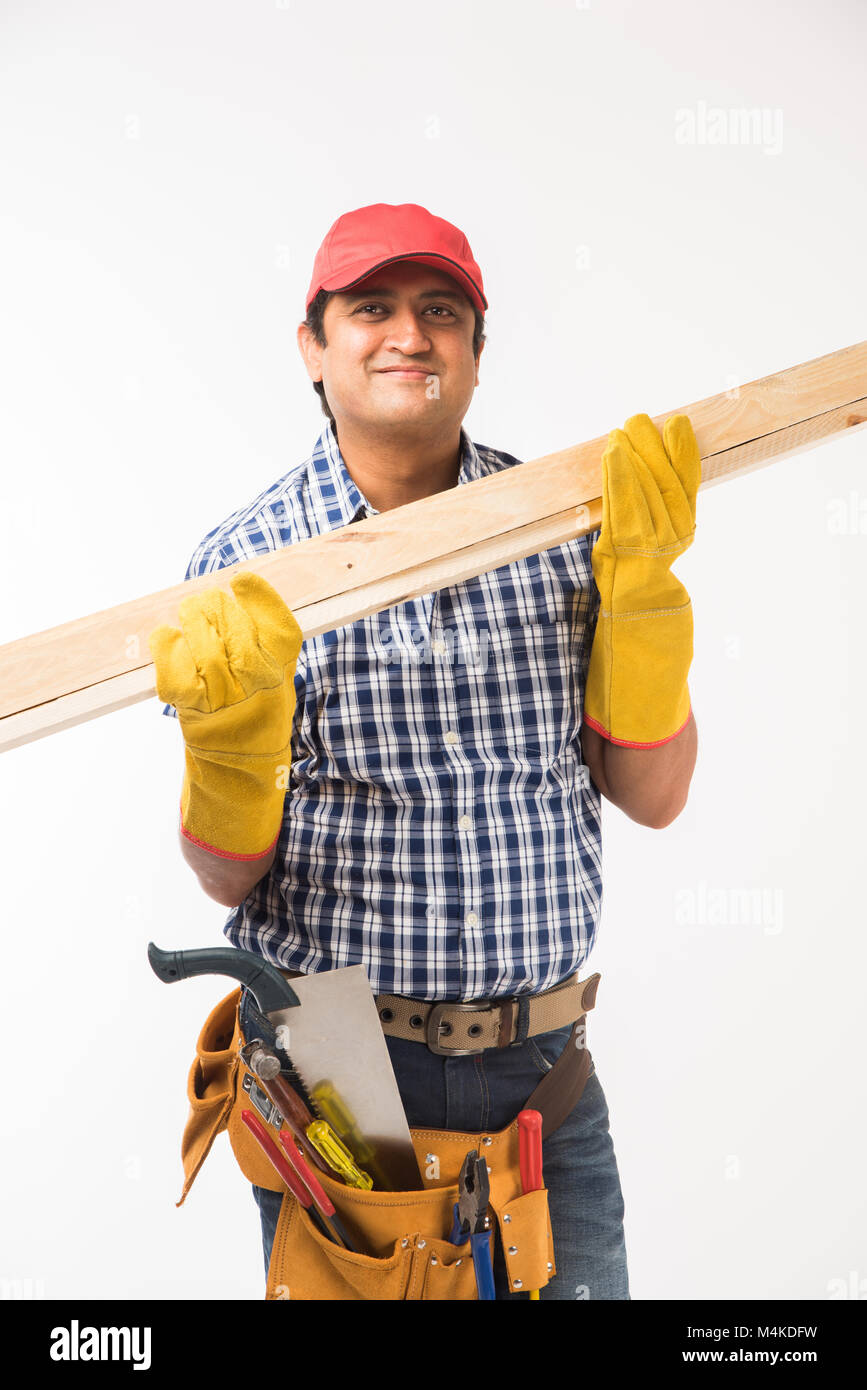 Handsome Indian Carpenter or wood worker in action, isolated over white ...