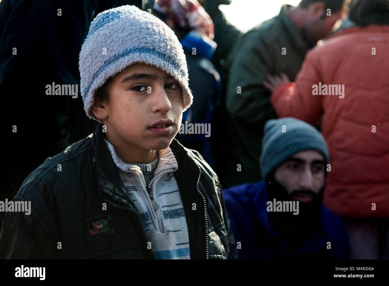 Portrait of a young refugee boy who just got off the dinghy on the ...