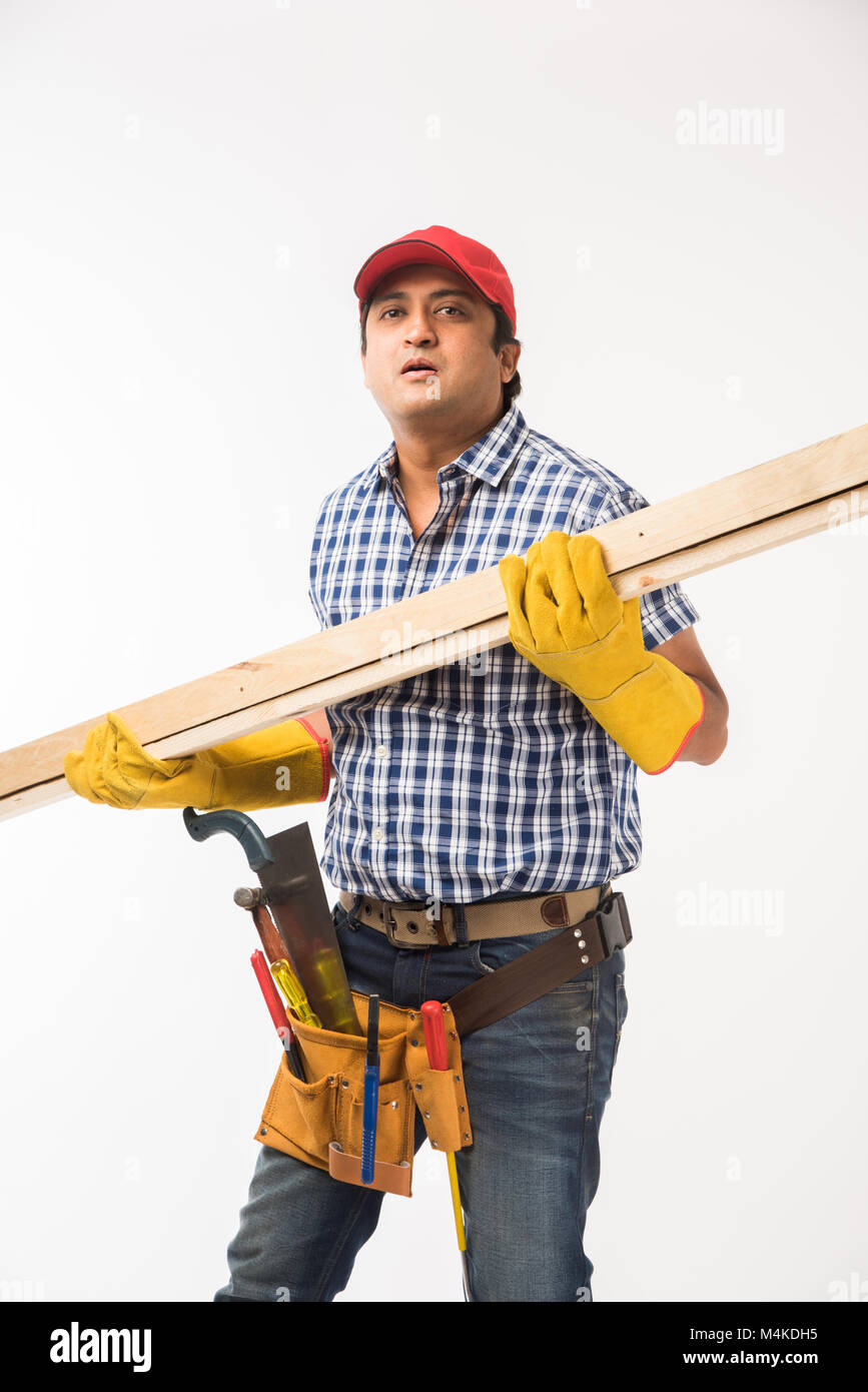 Handsome Indian Carpenter or wood worker in action, isolated over white ...
