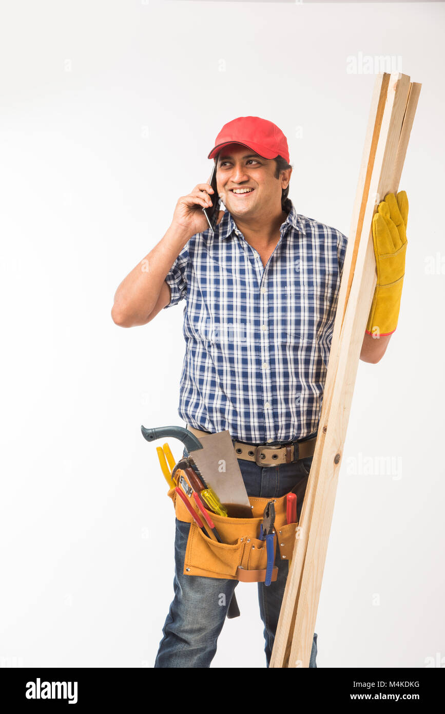 Handsome Indian Carpenter or wood worker in action, isolated over white ...