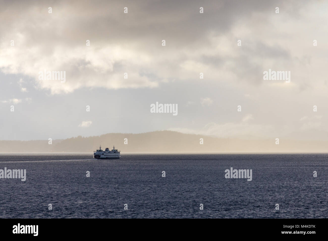 Overcast sky with rain falling in the distance on Pudget Sound with a ...