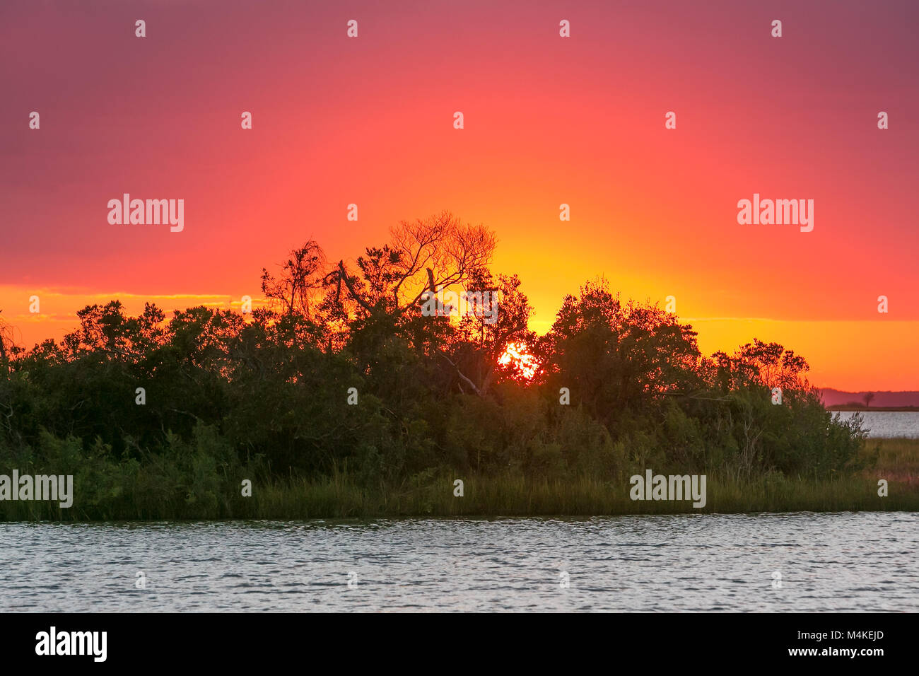 A brilliant sunset on the bay at Assateague Island National Seashore ...