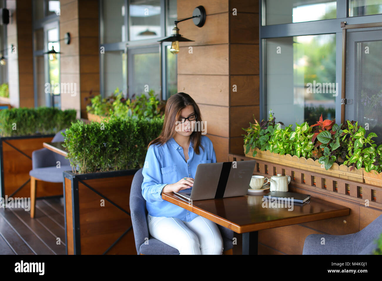 Beautiful girl browsing by laptop at cafe Stock Photo - Alamy