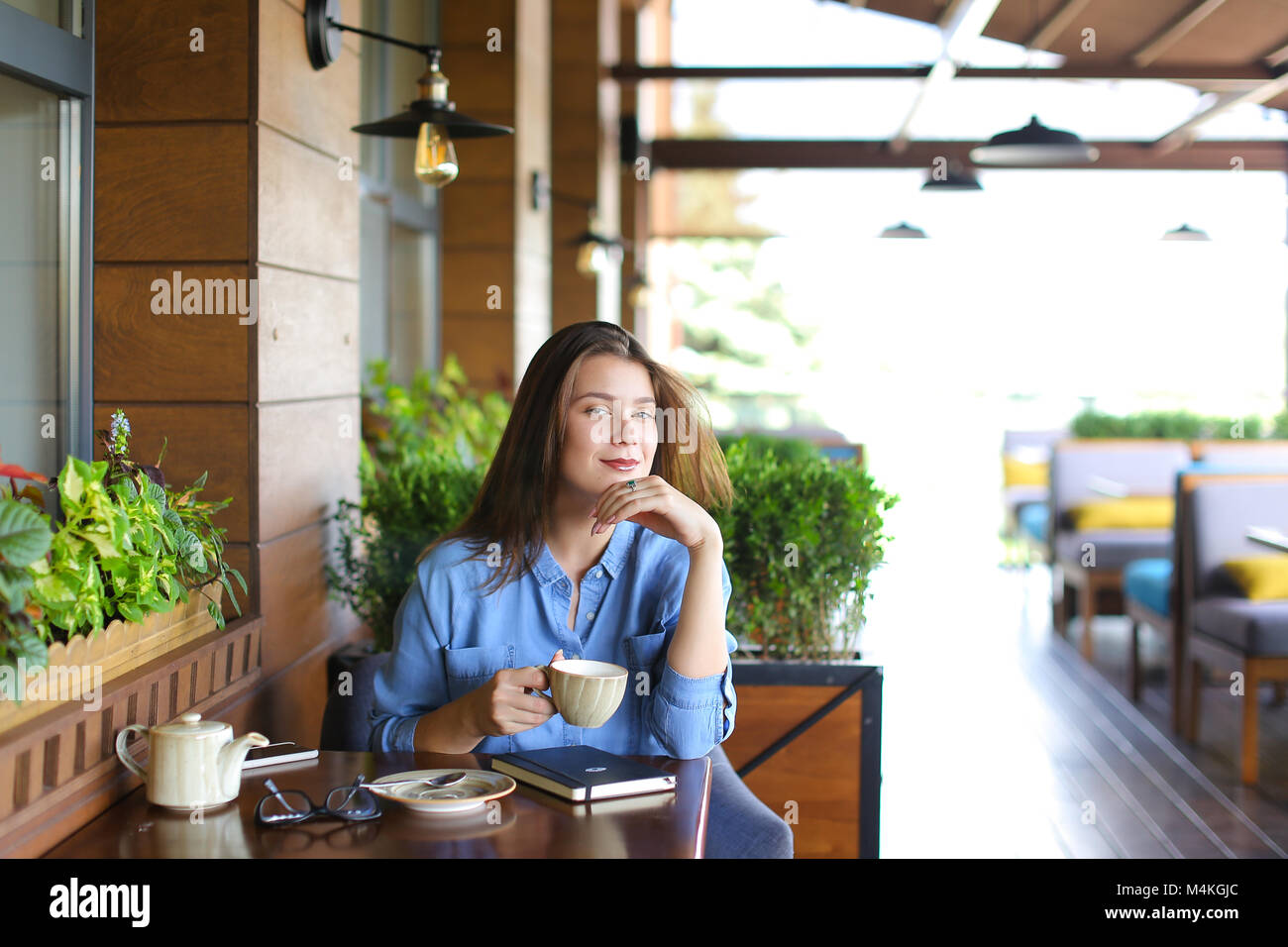 Charming girl drinking tea at restaurant Stock Photo - Alamy
