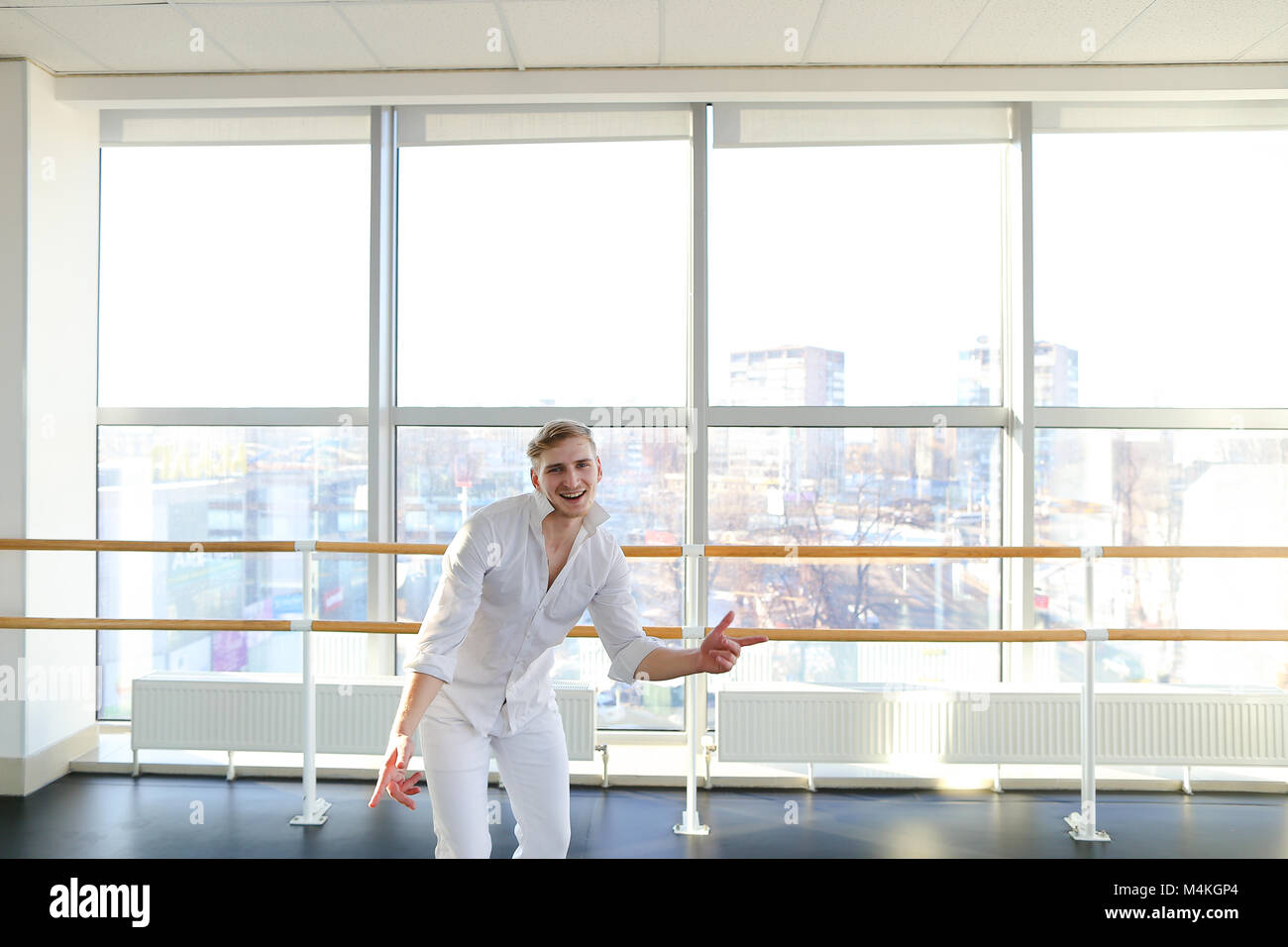 Guy spotting in white suit and raving at studio Stock Photo - Alamy