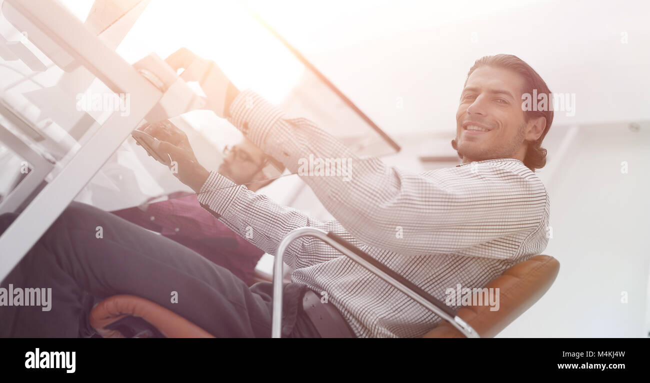 bottom view.businessman sitting behind a Desk Stock Photo - Alamy