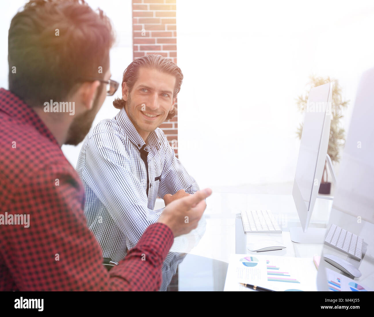employee explaining business analysis to his colleague Stock Photo - Alamy