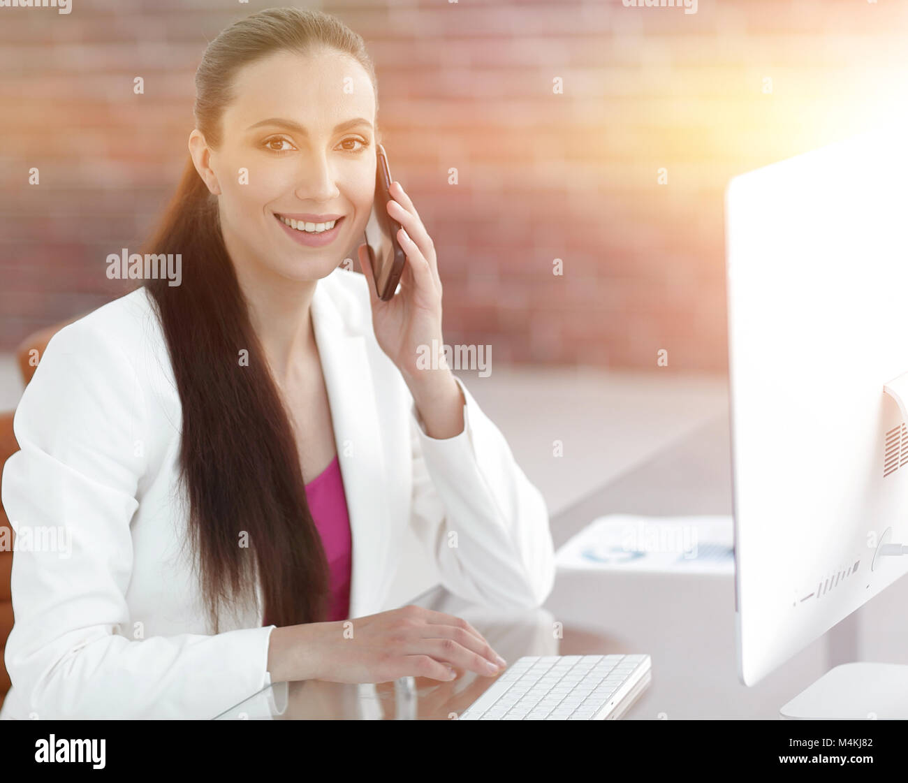 female assistant talking on the phone at his workplace in office Stock ...