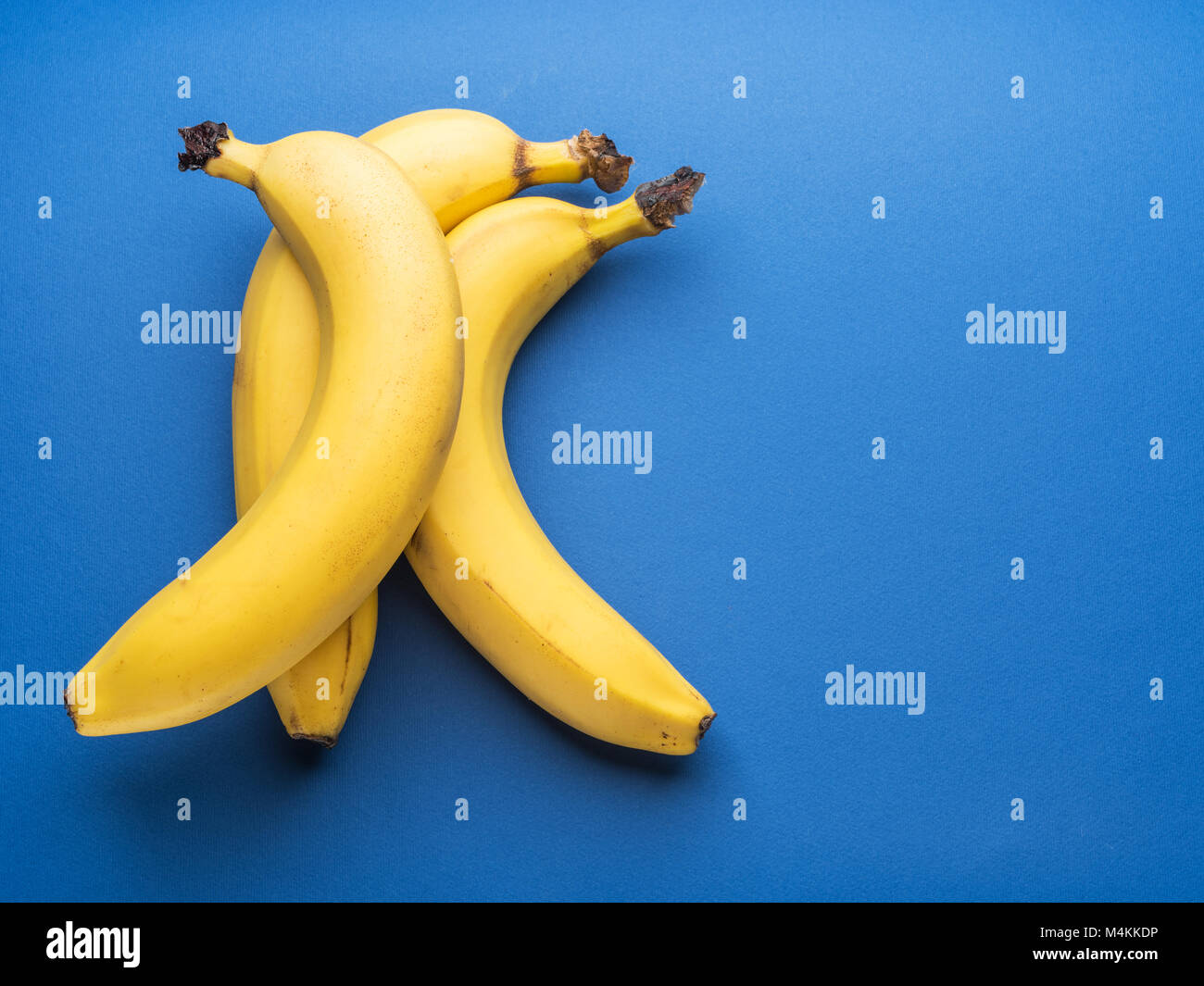 Bananas on the blue background Stock Photo - Alamy