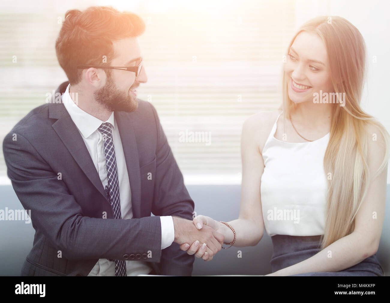 young candidate shaking hands with her employer after a job interview ...