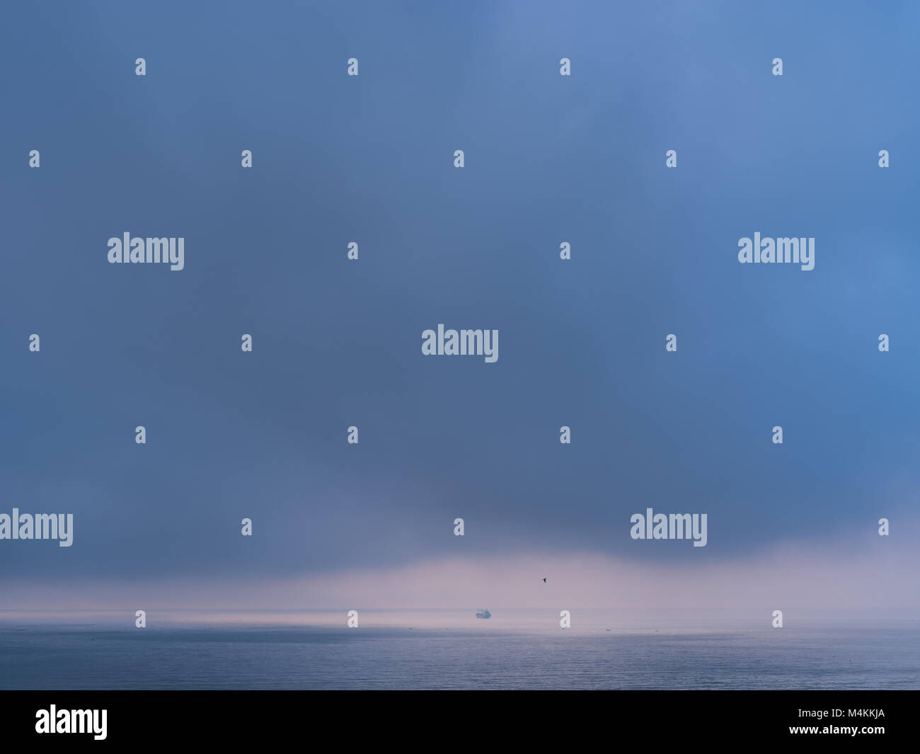Calm sea and heavy clouds in the sky Stock Photo - Alamy