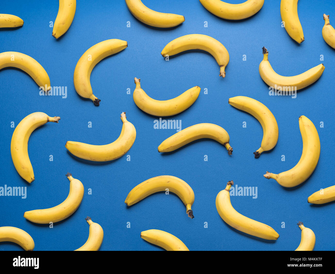 Bananas on the blue background Stock Photo - Alamy