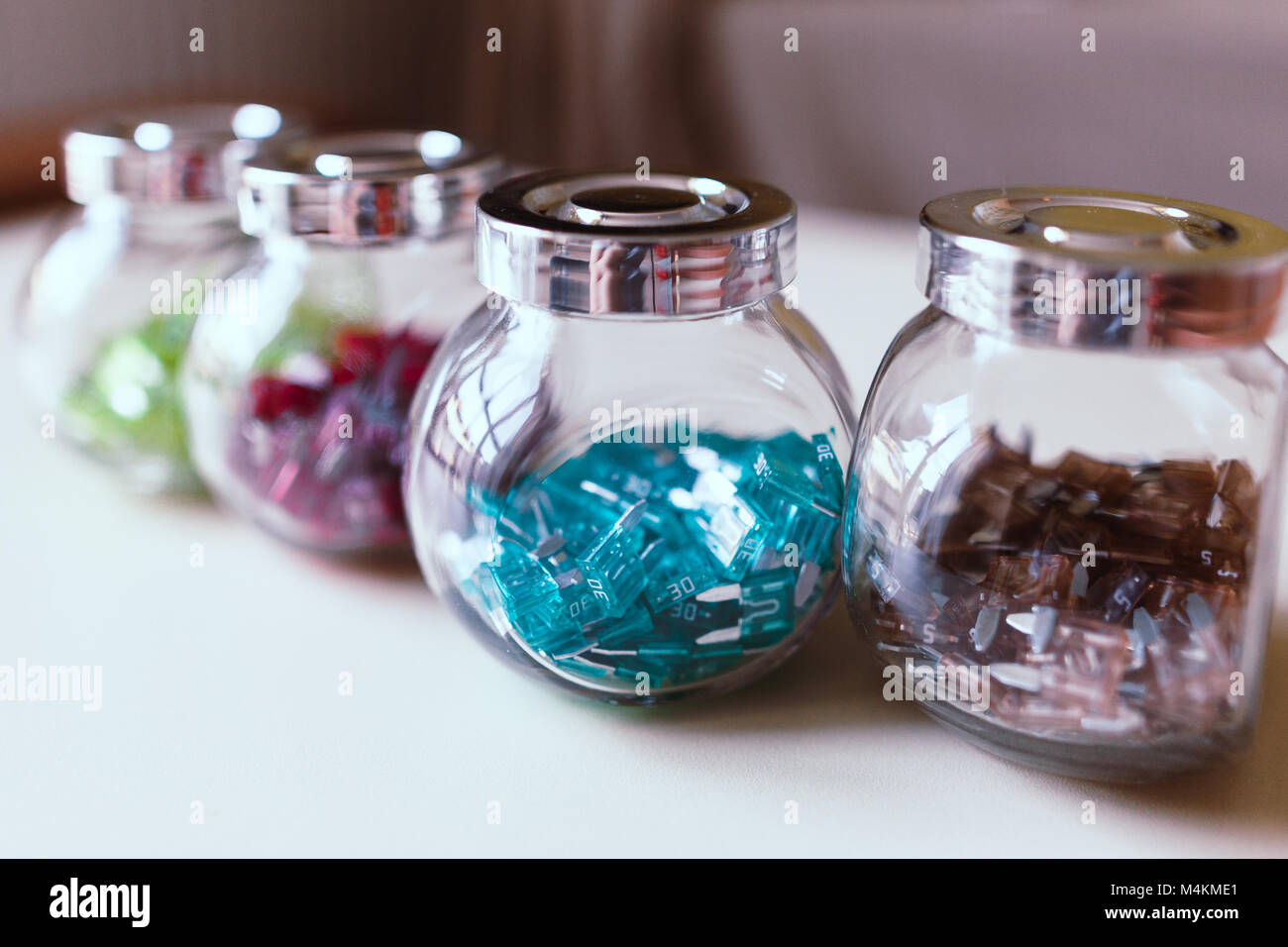 Car electric parts colorful mini fuses in kitchen spice rack on desk ...