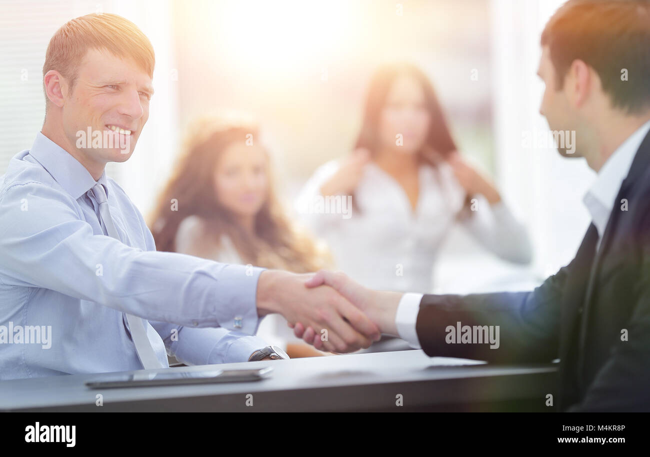handshake business partners at your Desk Stock Photo - Alamy