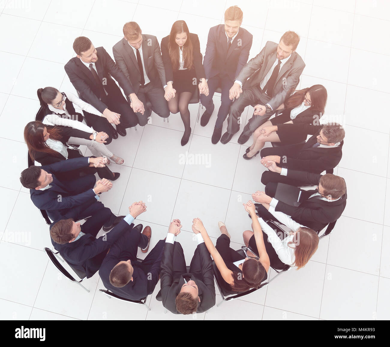 concept of team building.large business team sitting in a circle and ...