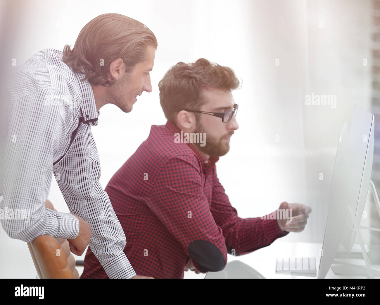 two Caucasian men working on a project in the workplace Stock Photo - Alamy