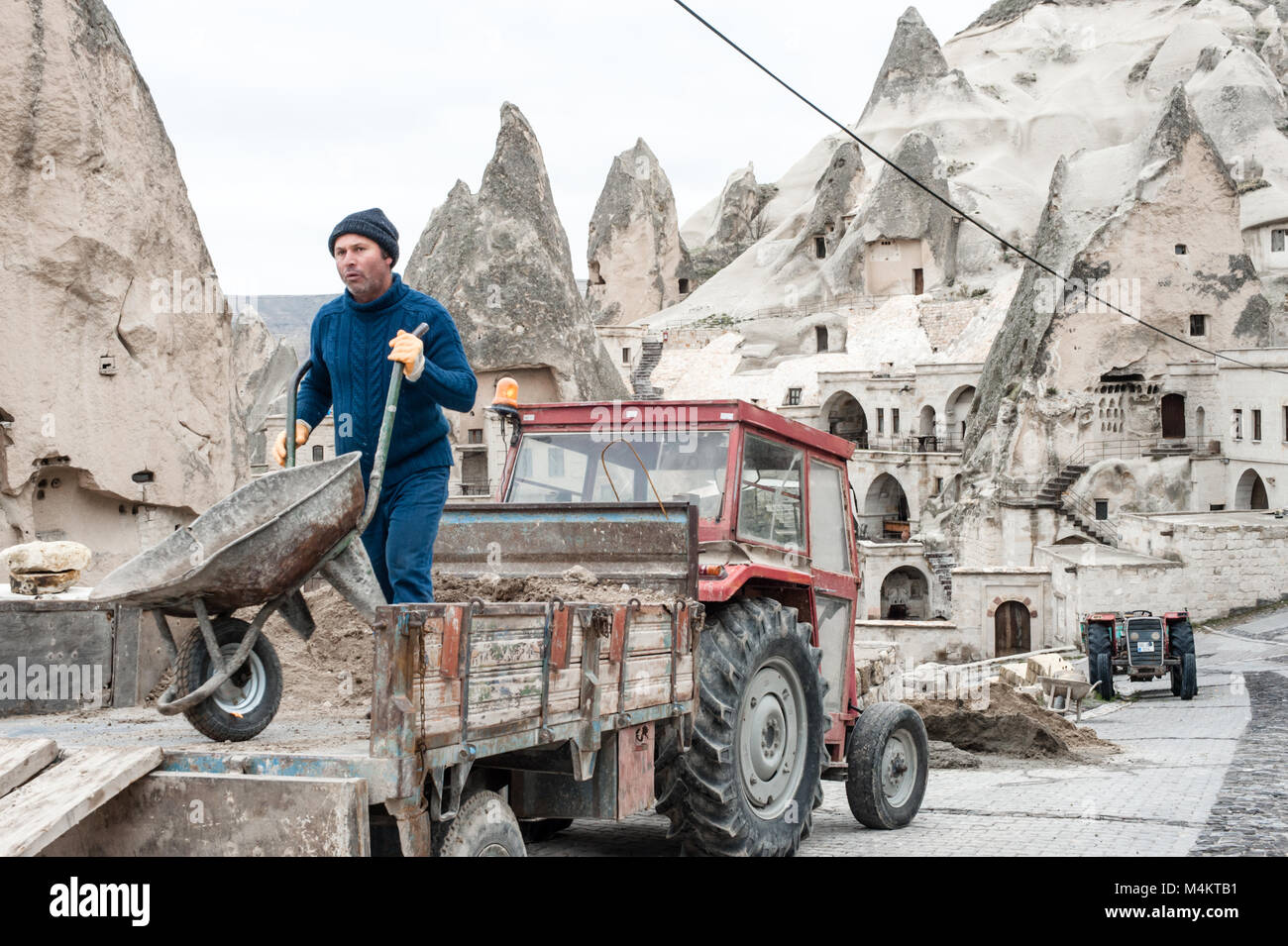 A builder renovating carved rock houses in Cappadocia, Turkey Stock ...