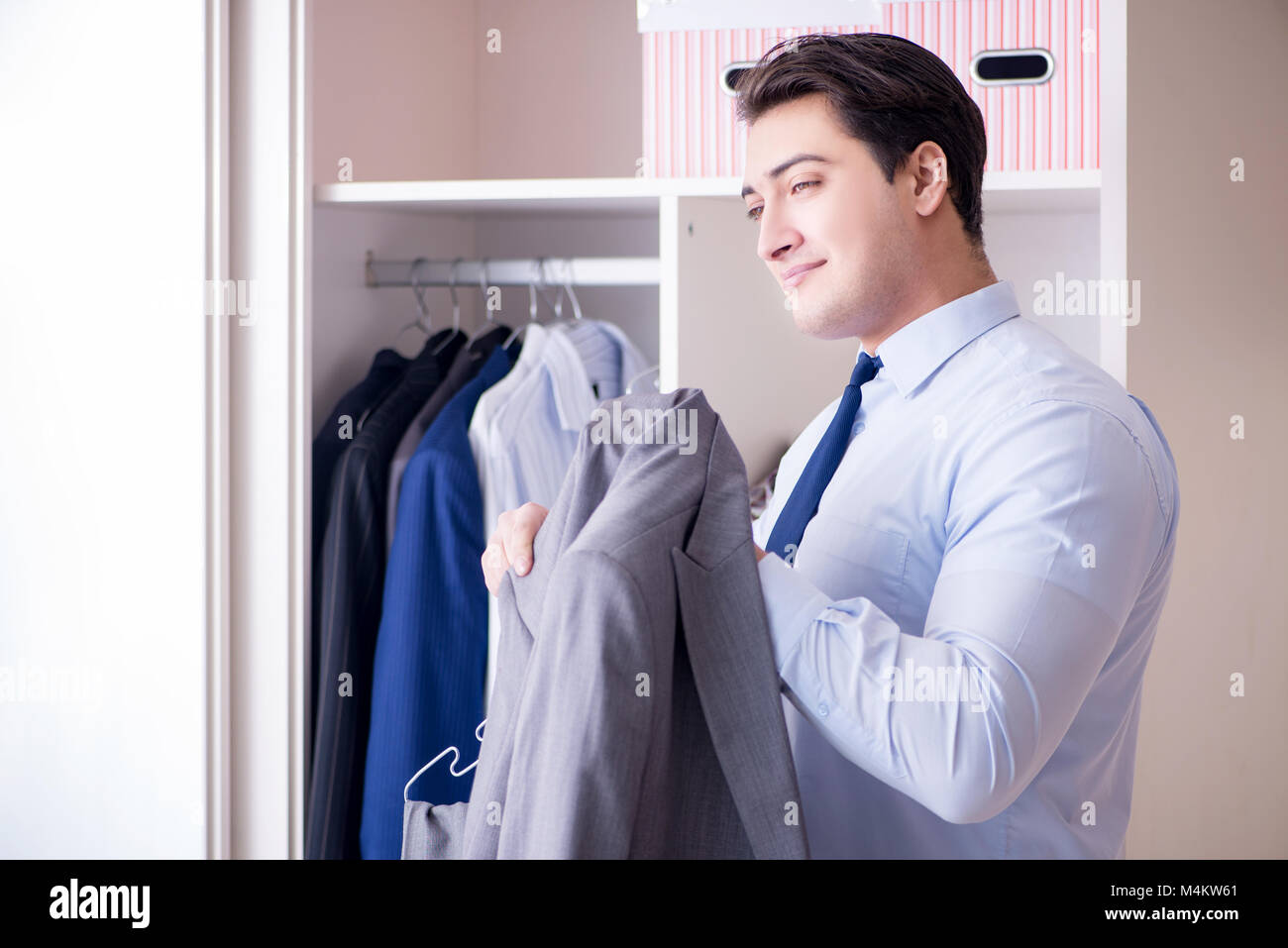 Young man businessman getting dressed for work Stock Photo - Alamy
