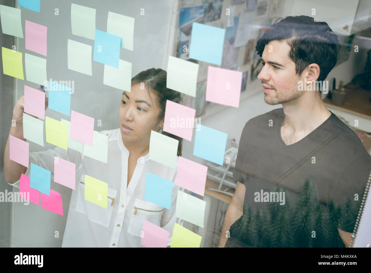 Business executives discussing over sticky notes Stock Photo - Alamy