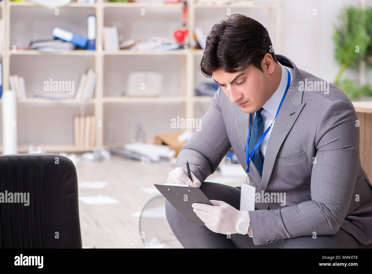 Young man during crime investigation in office Stock Photo - Alamy