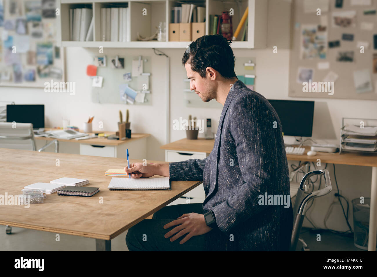 Executive writing note on diary Stock Photo - Alamy