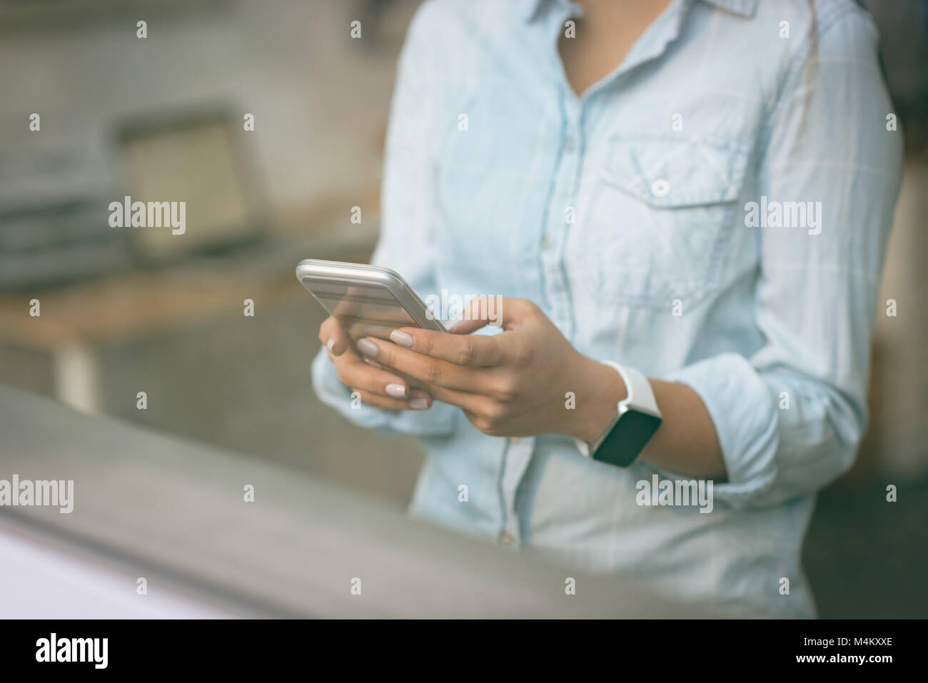 Executive using mobile phone in office Stock Photo - Alamy