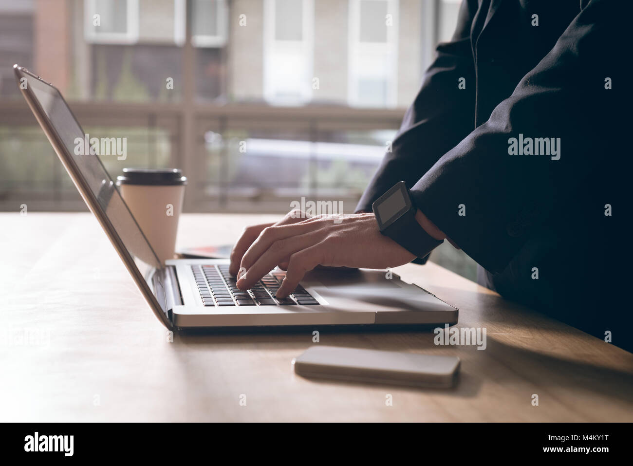 Executive working on laptop in office Stock Photo - Alamy