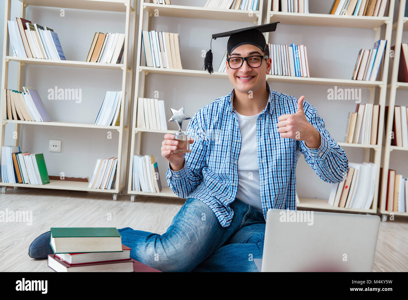 Young student studying with books Stock Photo - Alamy