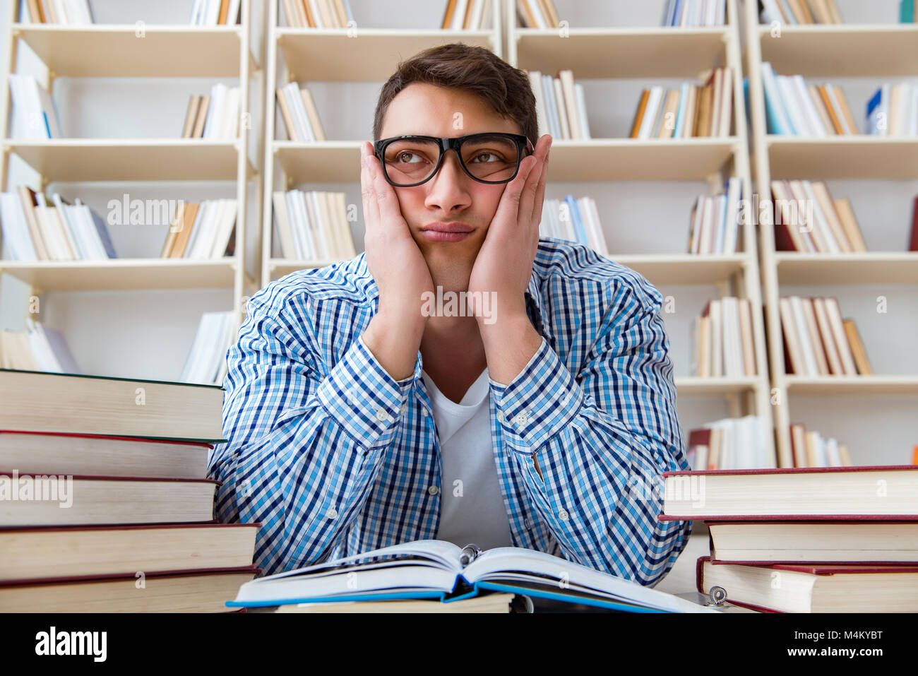 Young student studying with books Stock Photo - Alamy