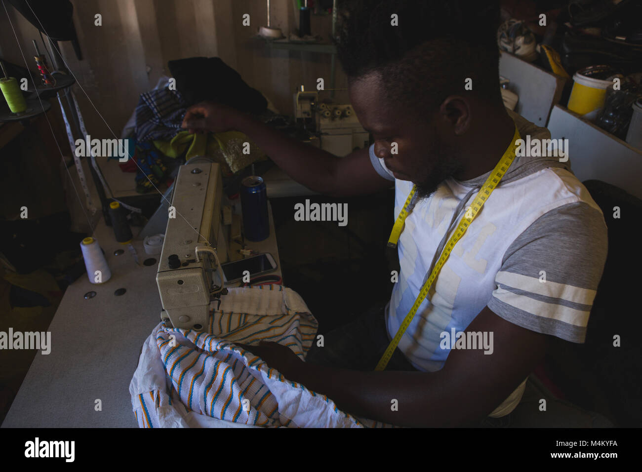 Tailor sewing clothes on sewing machine Stock Photo - Alamy