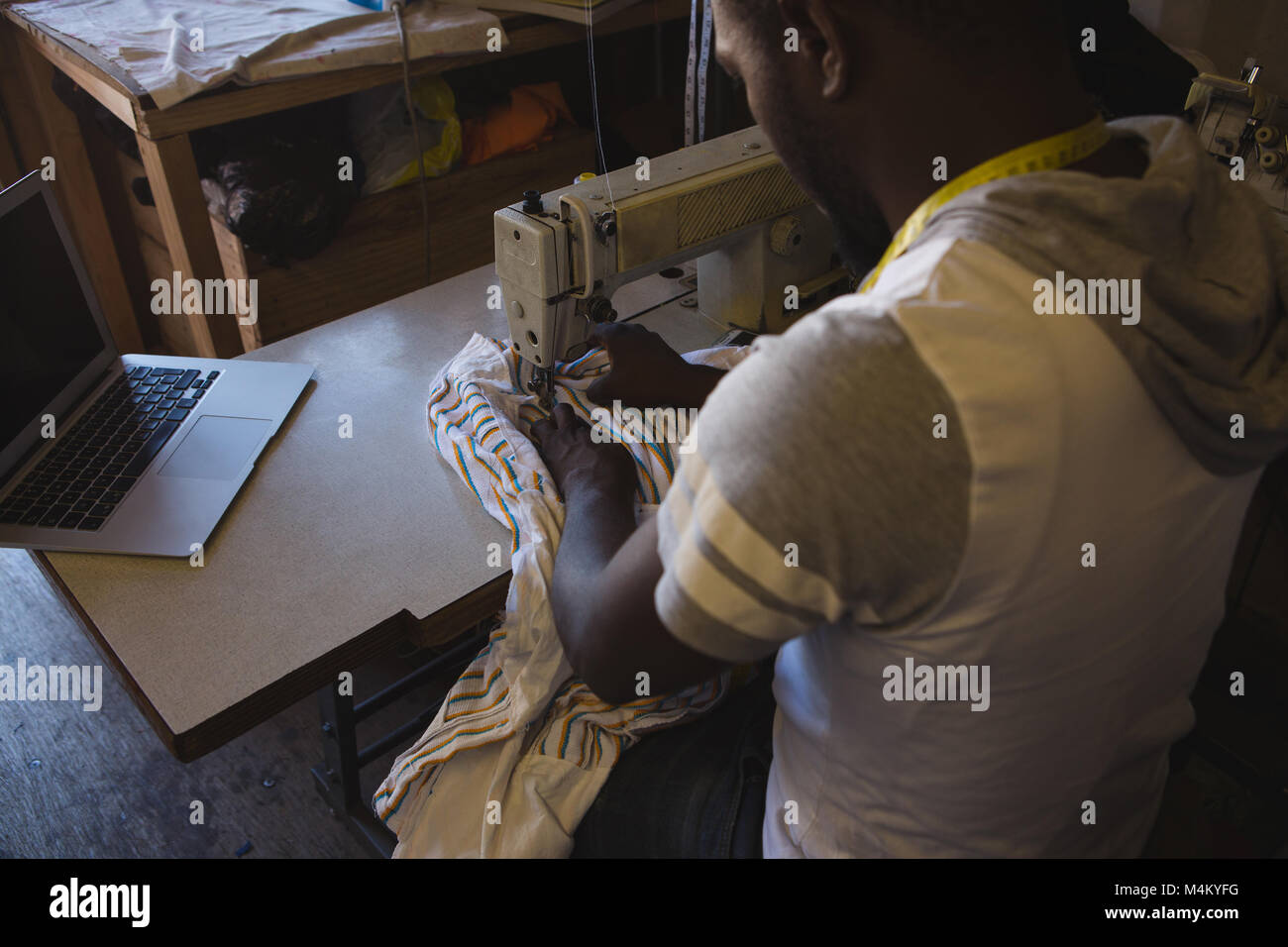 Tailor sewing clothes on sewing machine Stock Photo - Alamy
