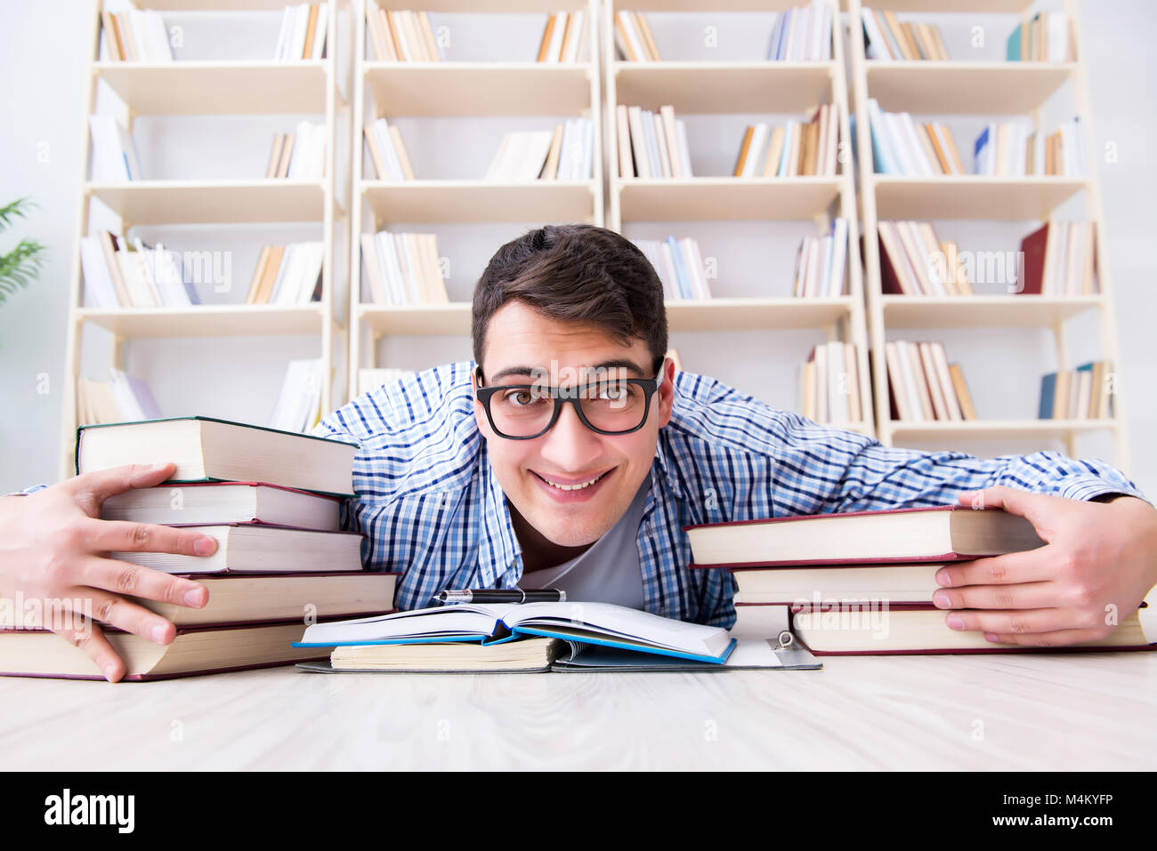 Young student studying with books Stock Photo - Alamy