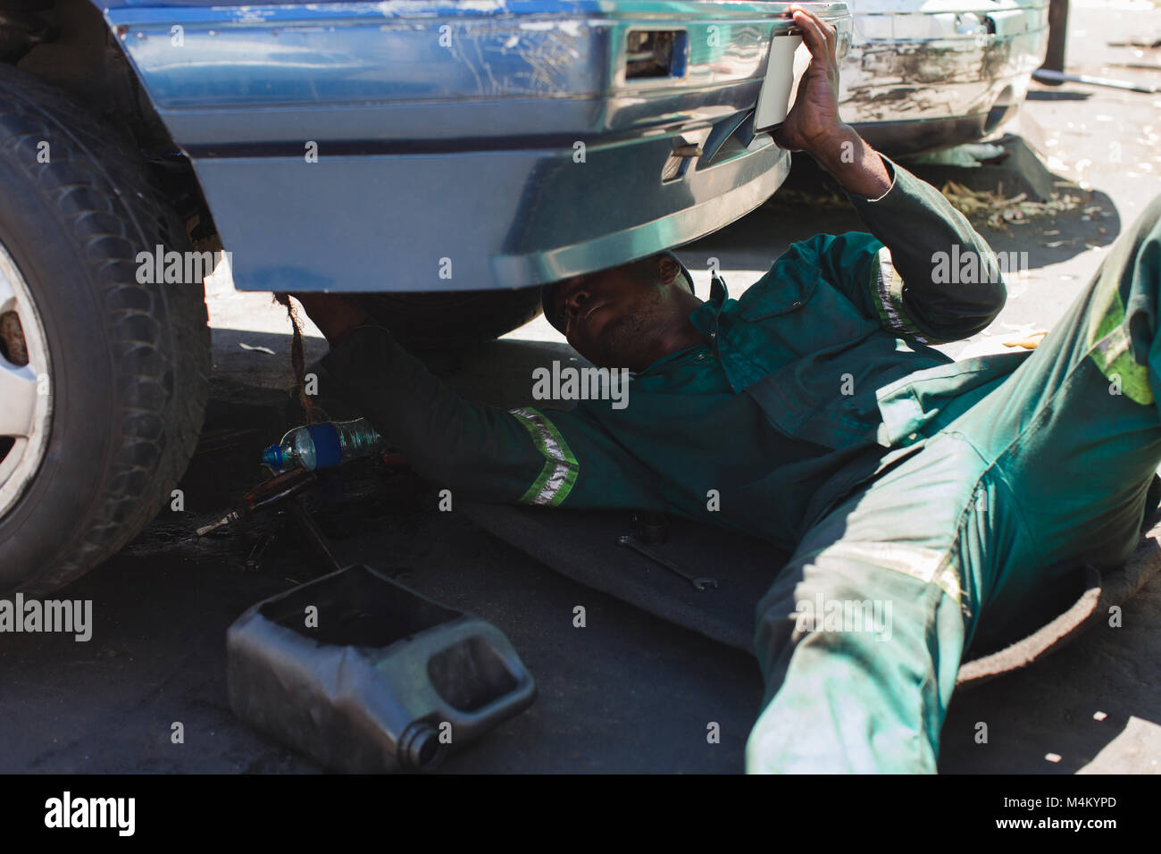 Mechanic repairing a car Stock Photo - Alamy