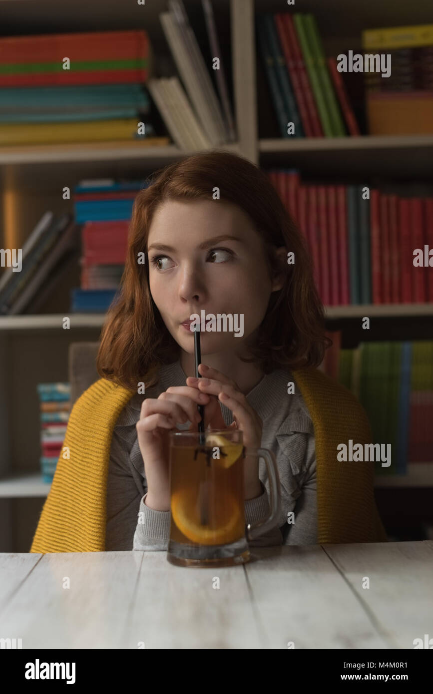 Woman having lemon juice with straw Stock Photo - Alamy