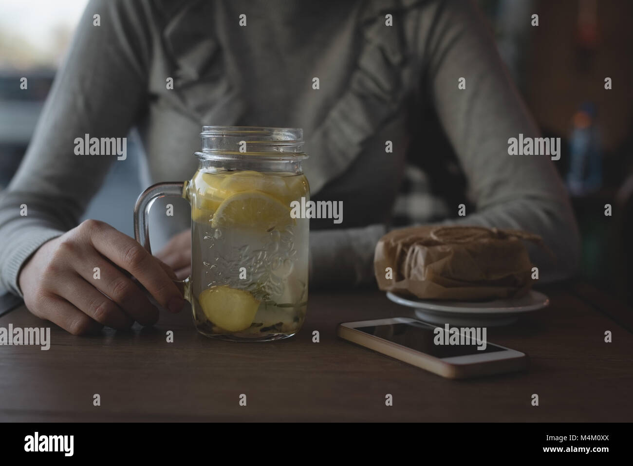 Woman having lemon tea in cafe Stock Photo - Alamy