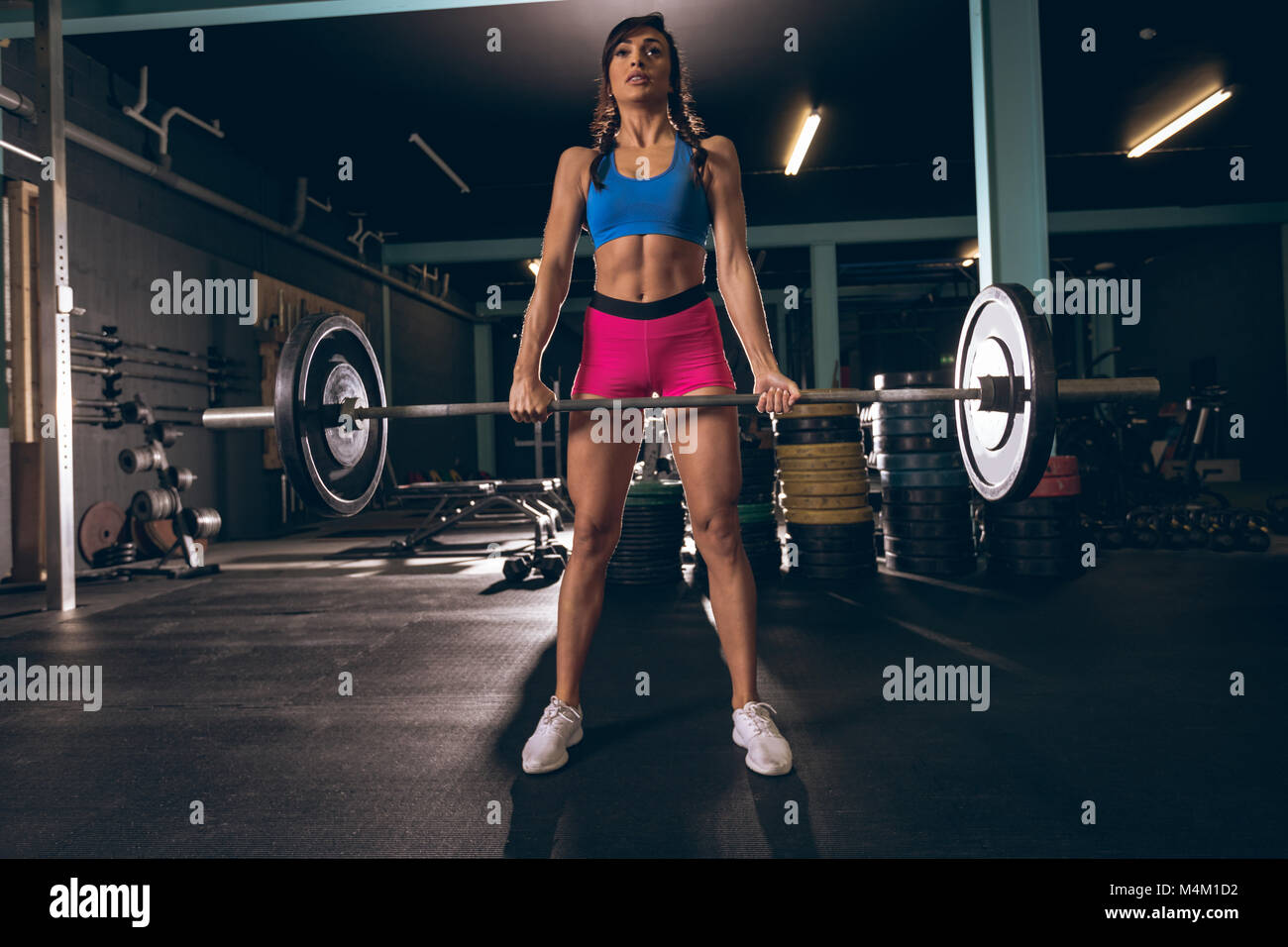 Fit woman lifting the barbell Stock Photo - Alamy