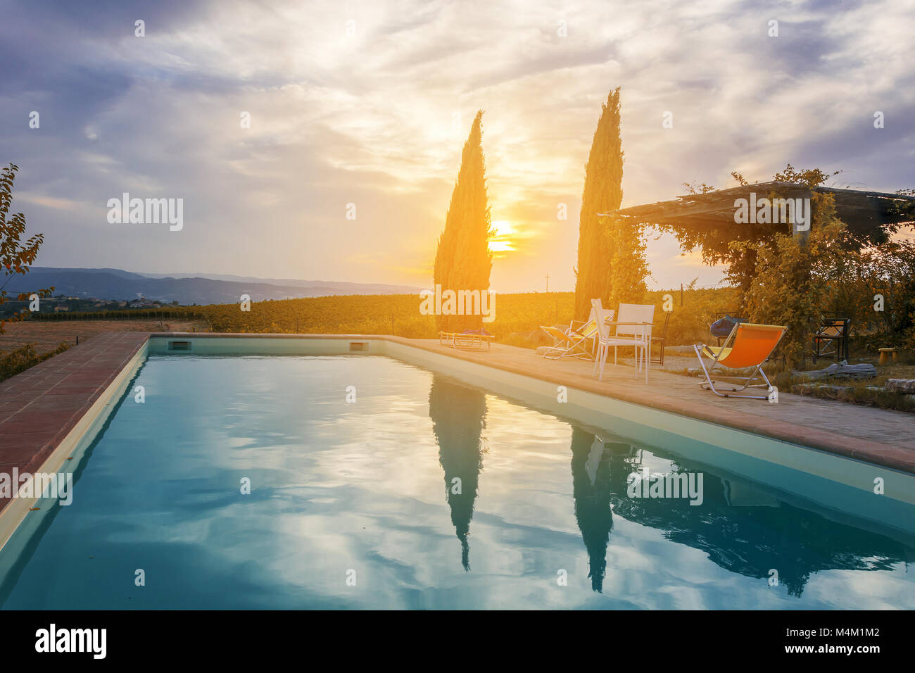 sunset over a pool Stock Photo - Alamy