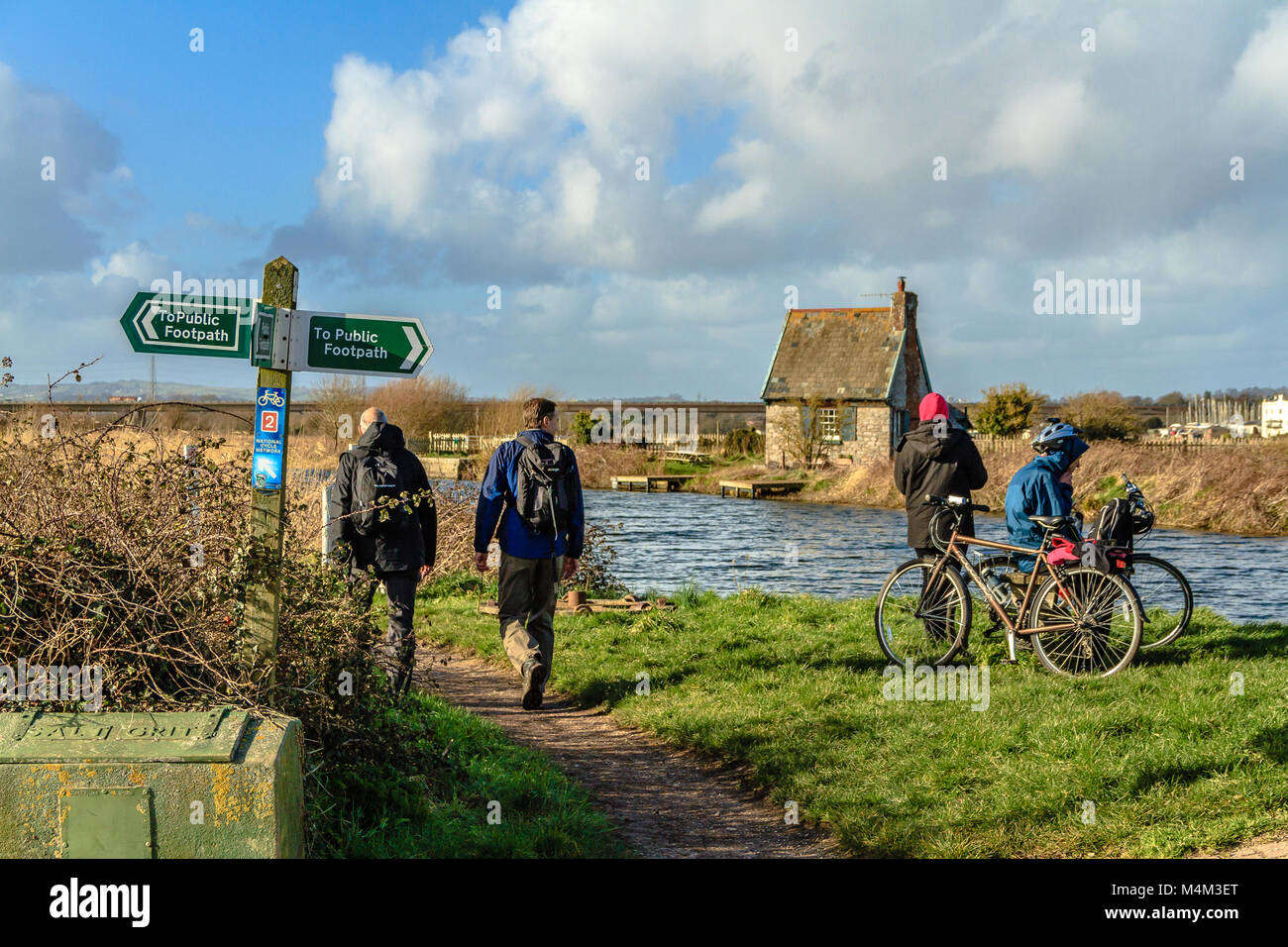 Cyclists and walkers on the Exe Estuary Trail by Topsham Lock Cottage ...