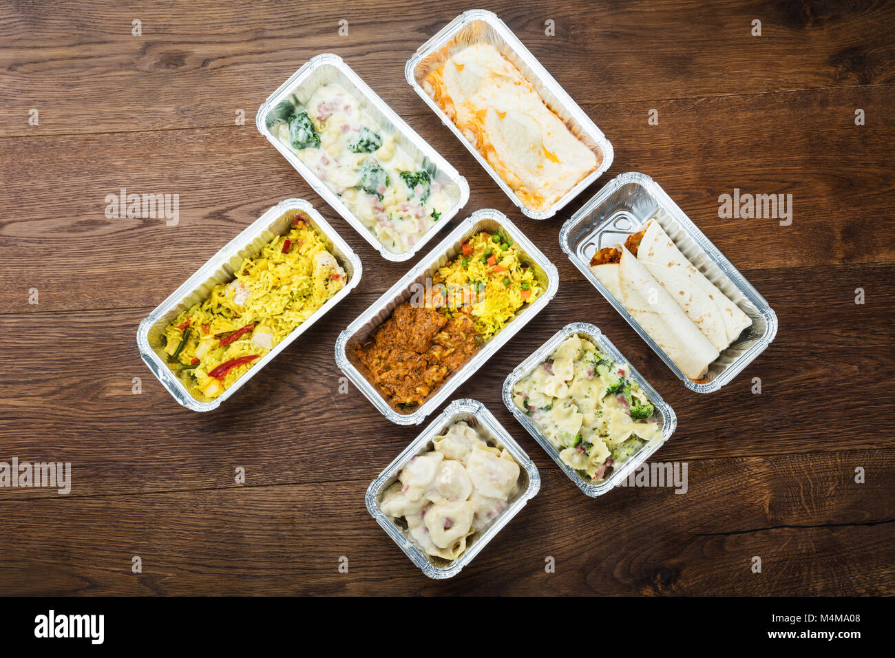 Different Type Of Ready Tasty Meals In Foil Containers On The Table ...