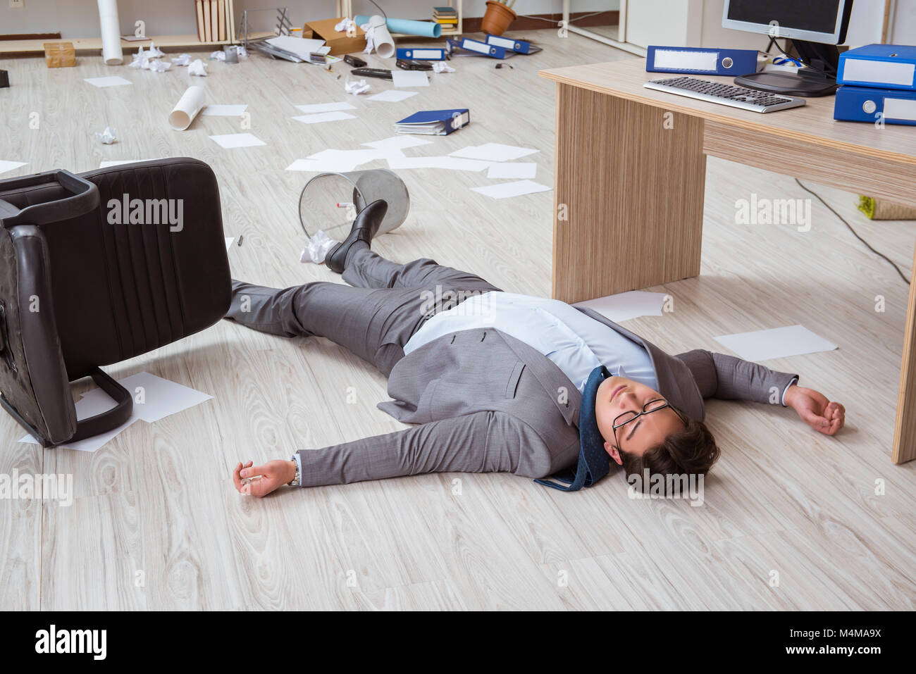 Businessman dead on the office floor Stock Photo - Alamy