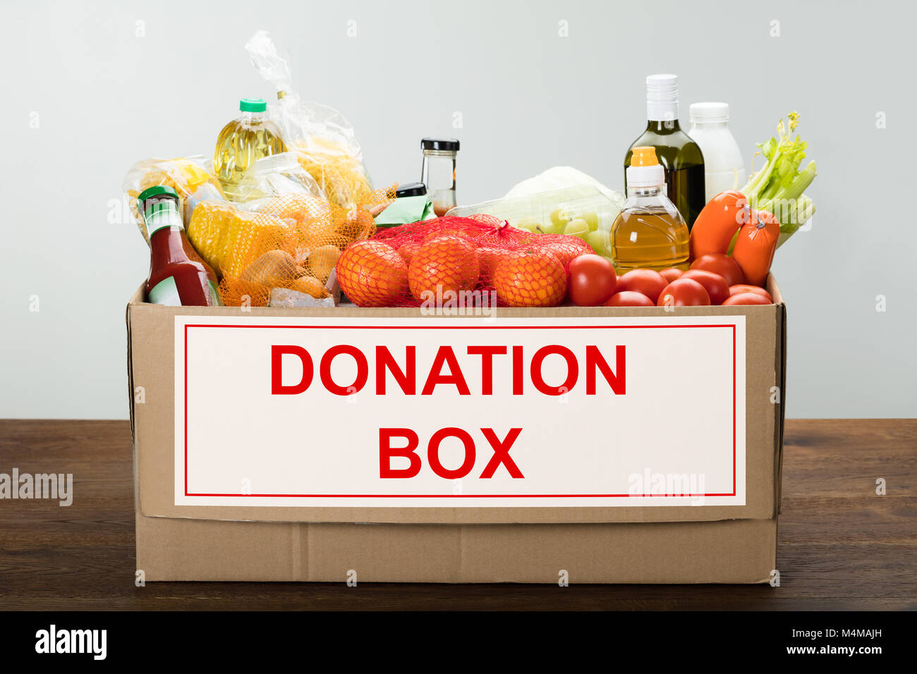 Donation Box Full Of Groceries On Table Stock Photo - Alamy