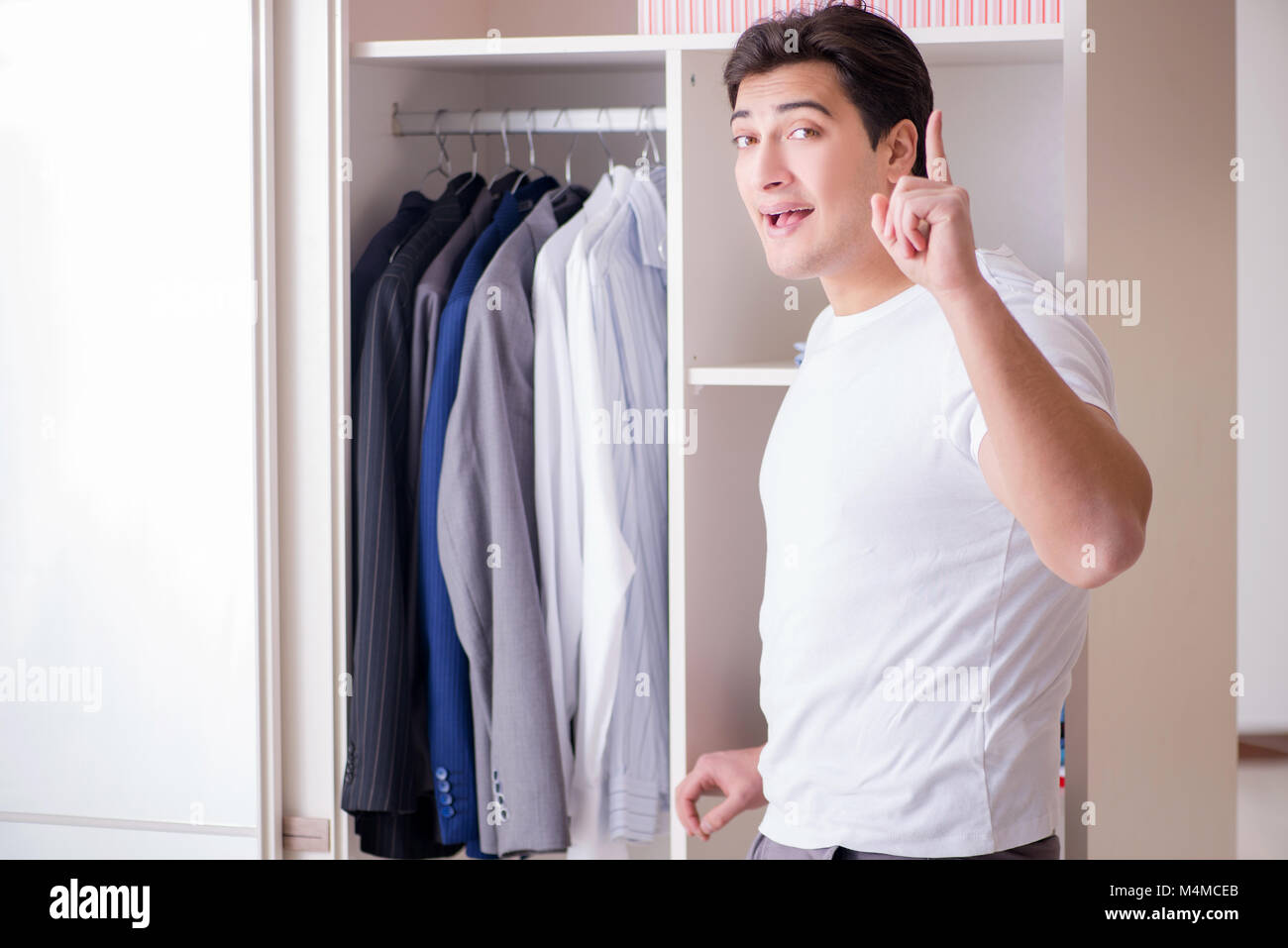 Young man businessman getting dressed for work Stock Photo - Alamy