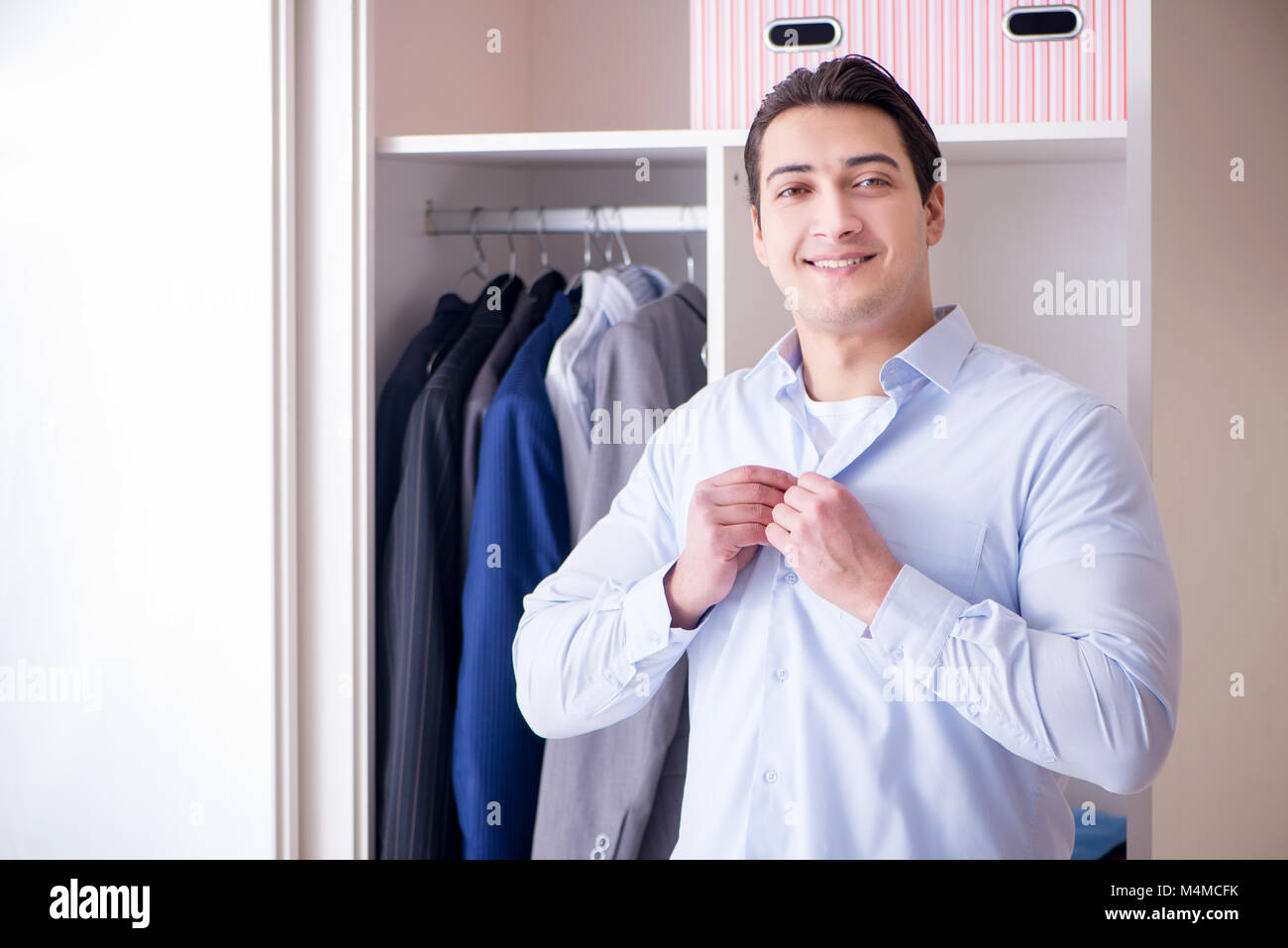 Young man businessman getting dressed for work Stock Photo - Alamy